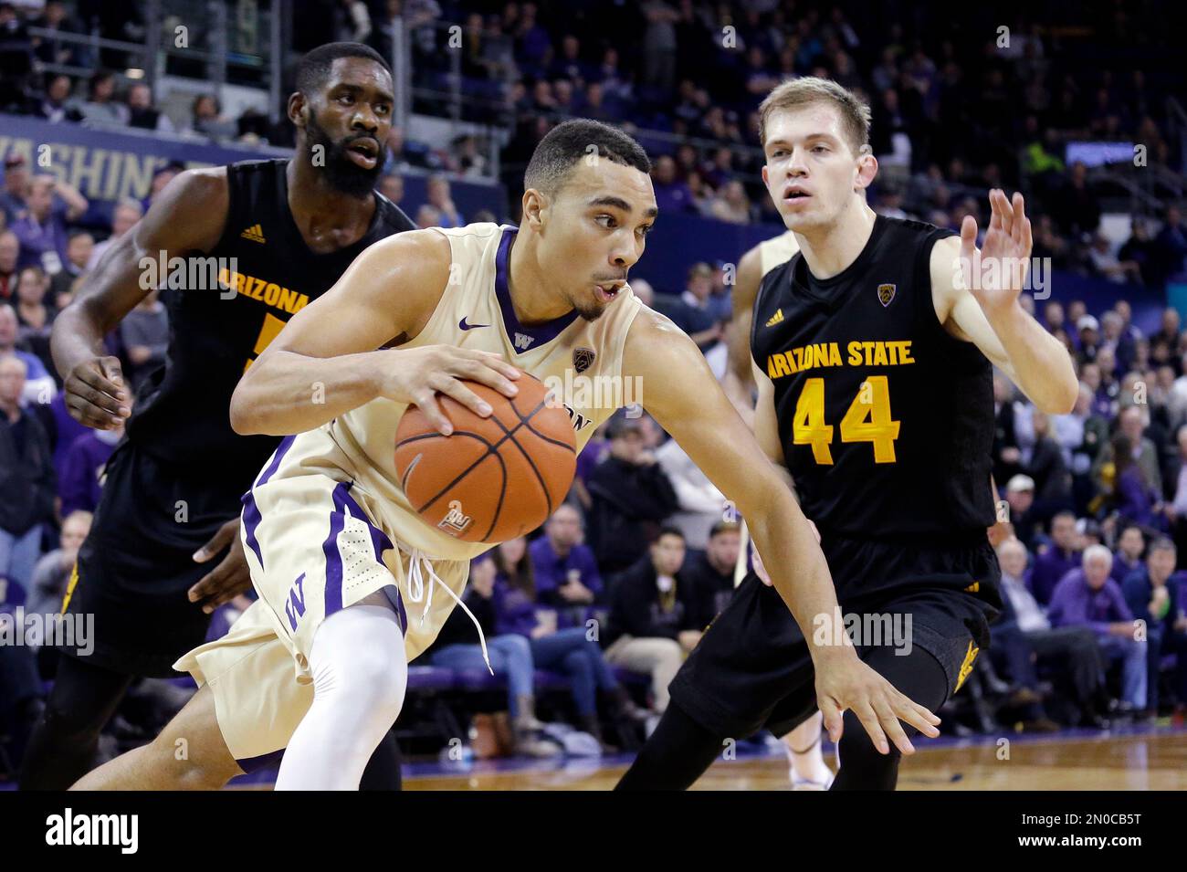 Washington's Andrew Andrews, center, drives around Arizona State's Kodi ... Washington's Andrew Andrews, center, drives around Arizona State's Kodi ...
