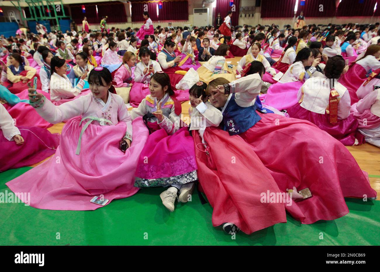 South Korean senior students clad in traditional dresses take a ...