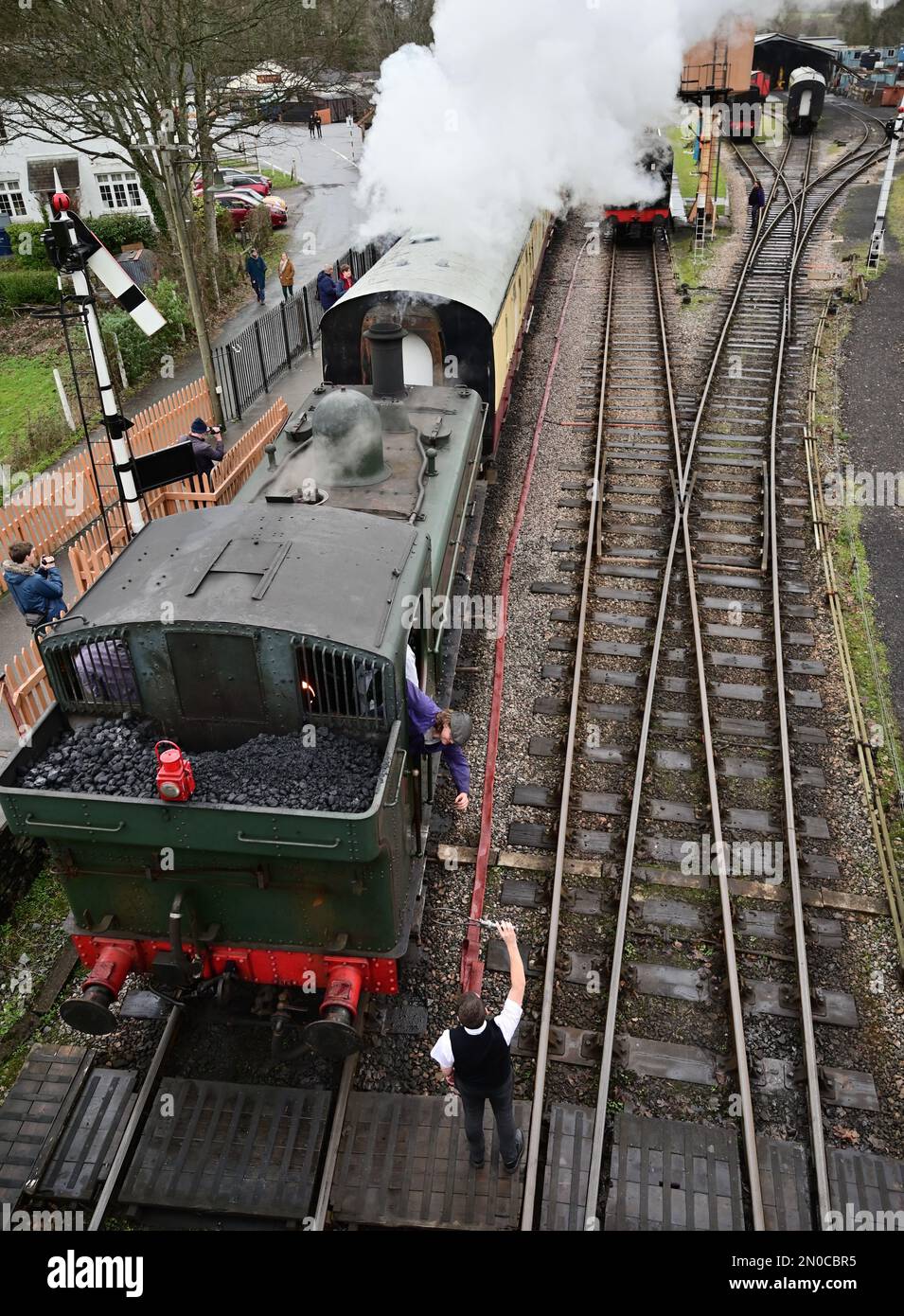 The fireman of GWR pannier tank No 6430 is collecting the single line ...