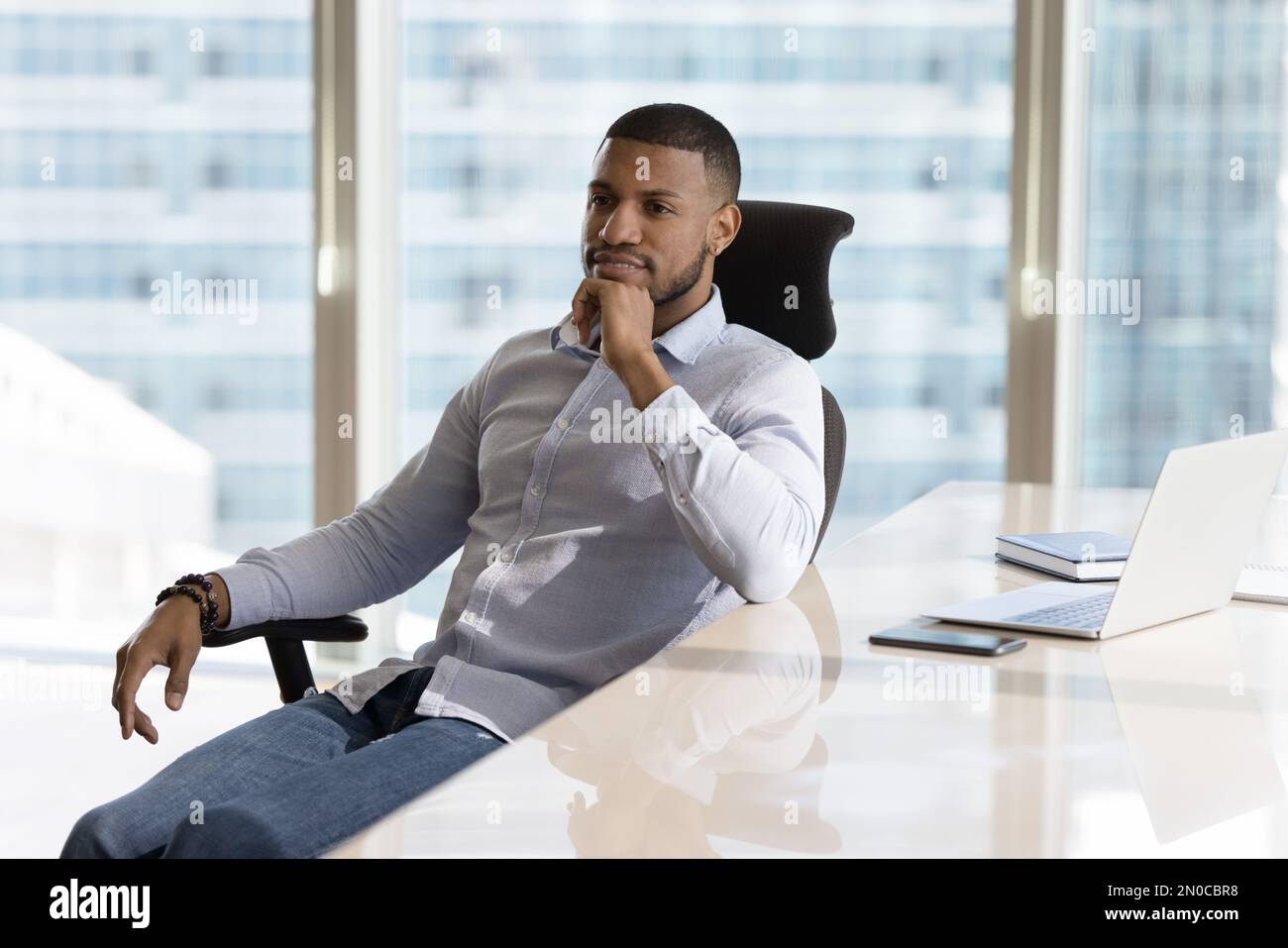 Happy dreamy millennial African employee man thinking over career ...