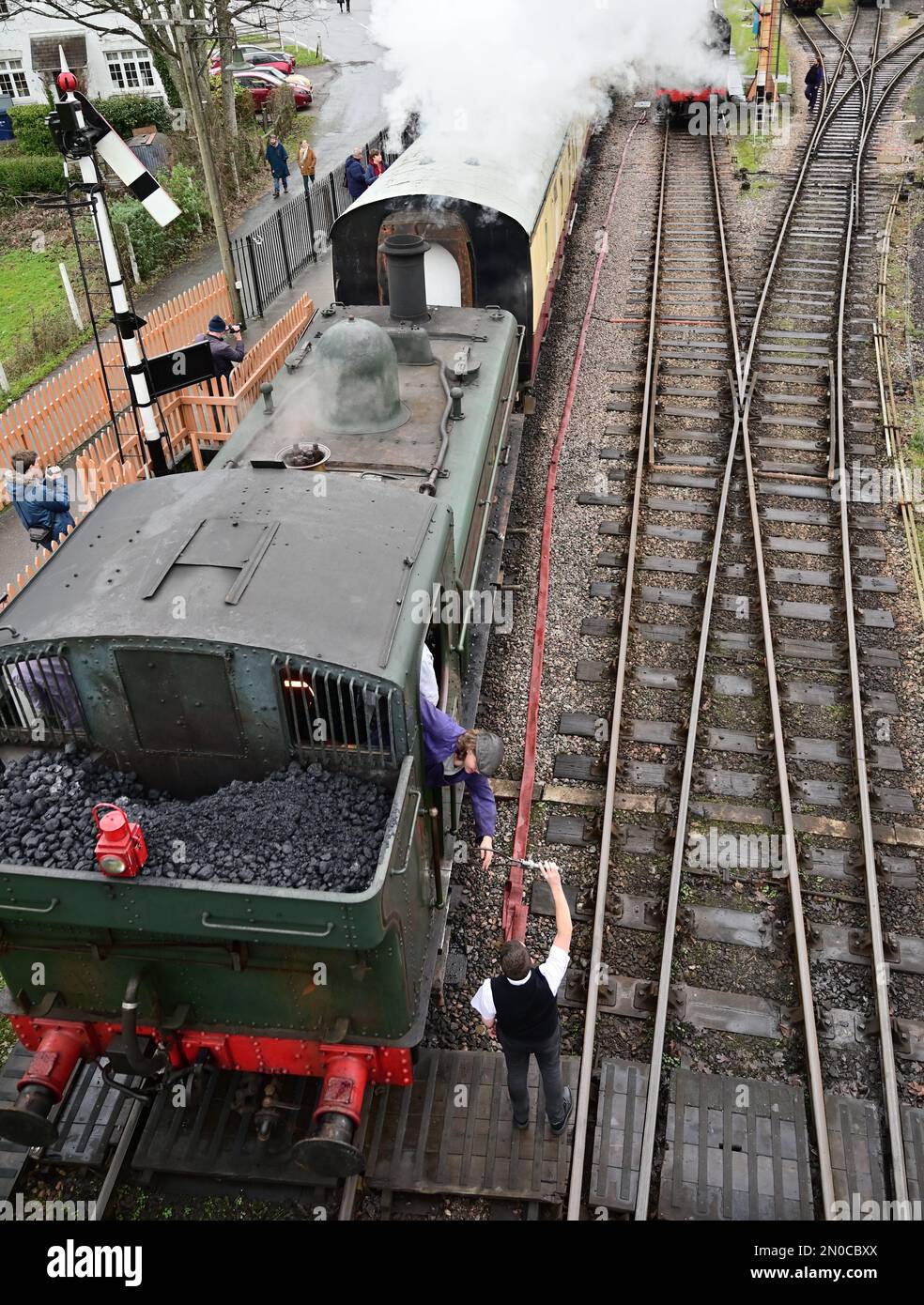 The fireman of GWR pannier tank No 6430 is collecting the single line ...