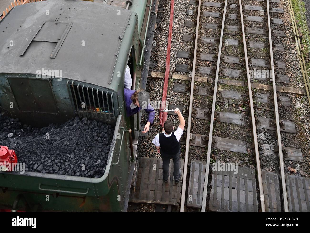 The fireman of GWR pannier tank No 6430 is collecting the single line ...