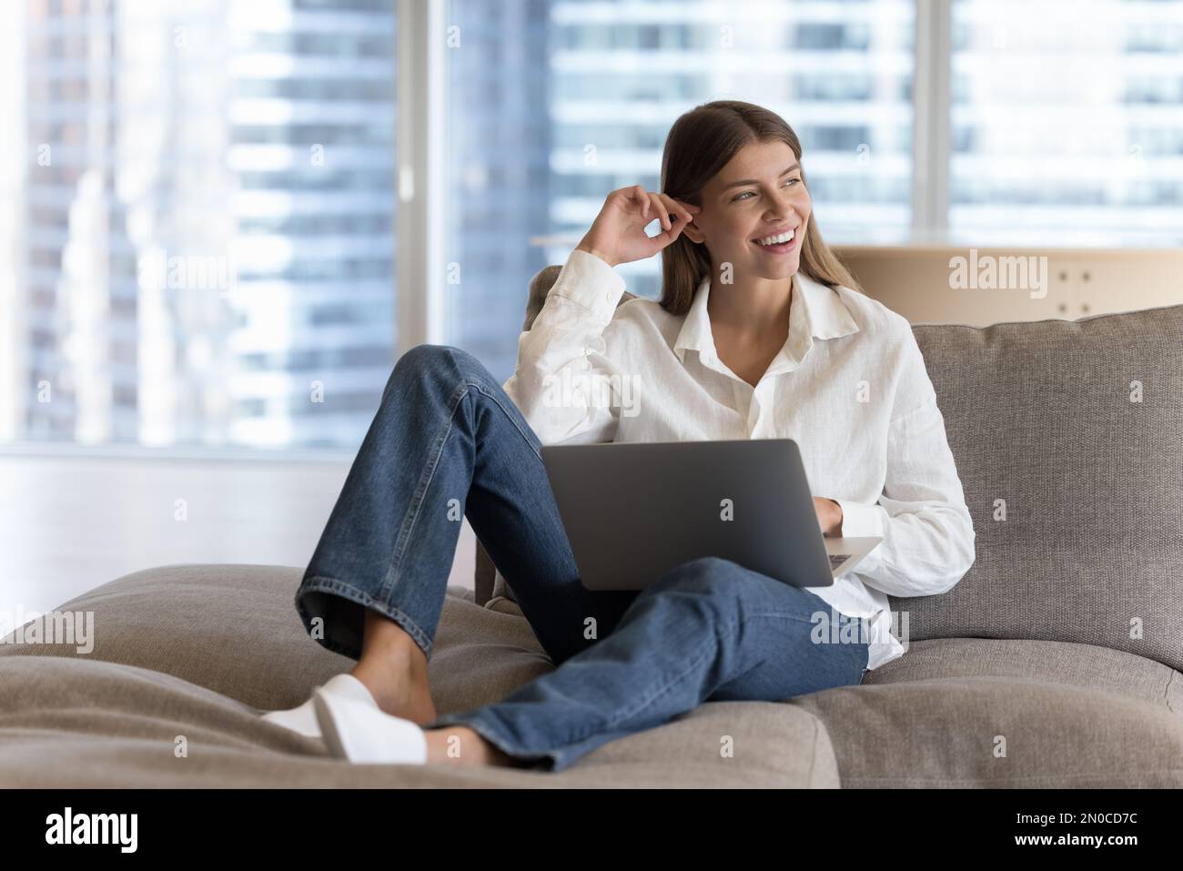 Happy pretty millennial freelance employee girl holding laptop Stock ...