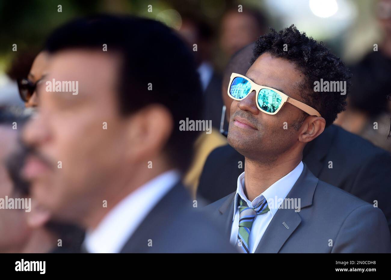 Singer Eric Benet, right, looks on during the opening ceremonies of the ...