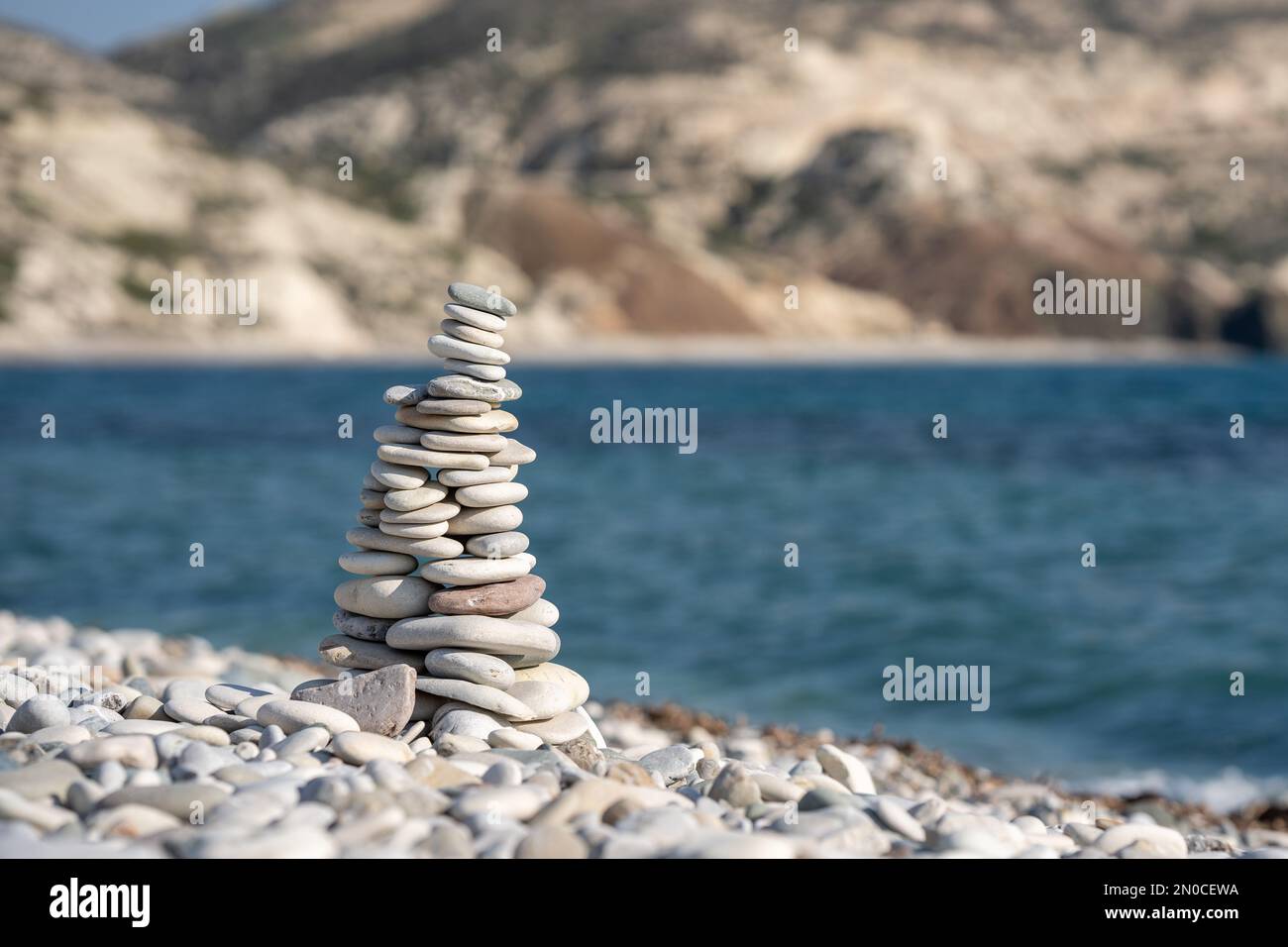 Stones pyramid on background of Mediterranean sea. Seashore background ...