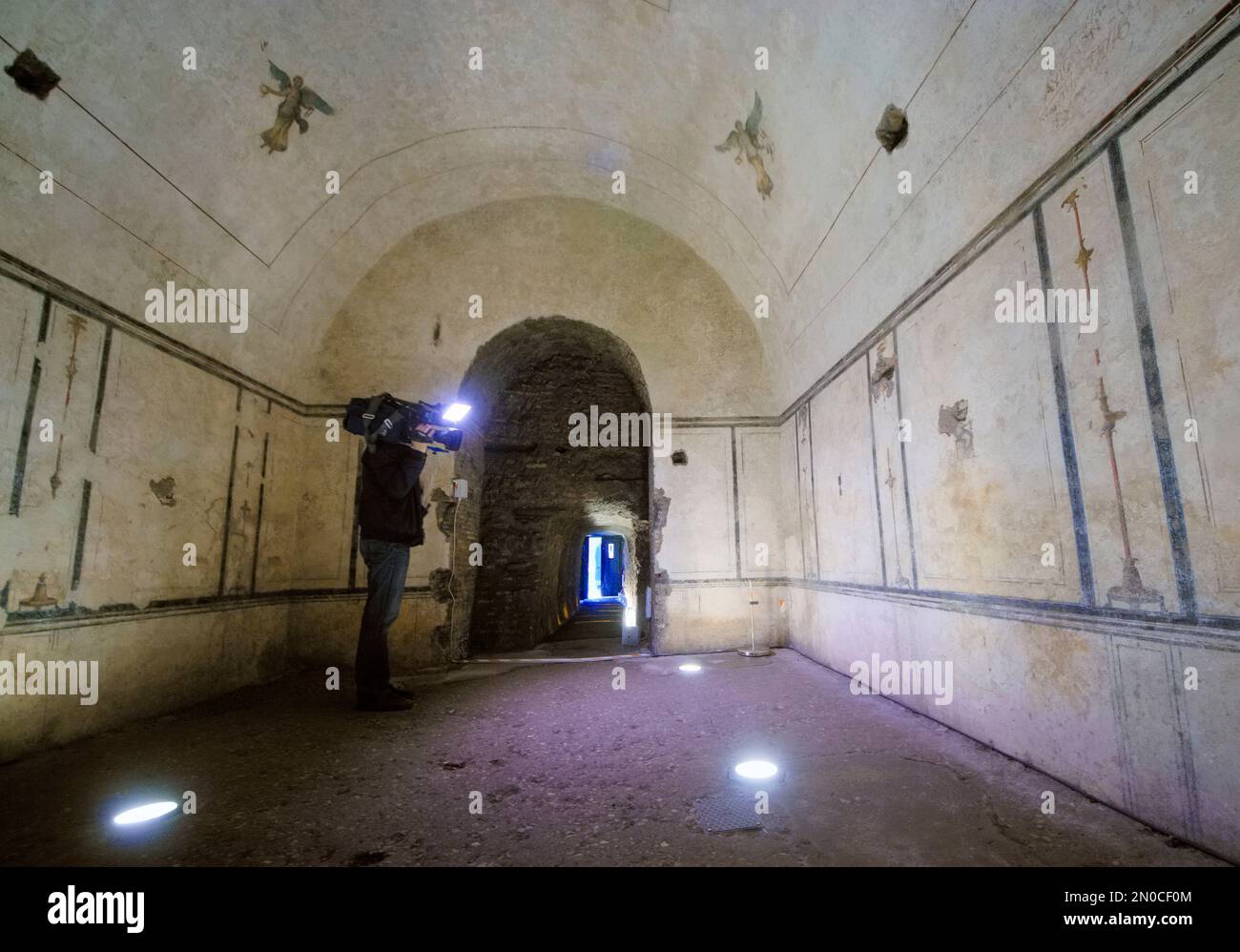 A cameraman films a frescoed chamber of the Pyramid of Cestius in Rome ...