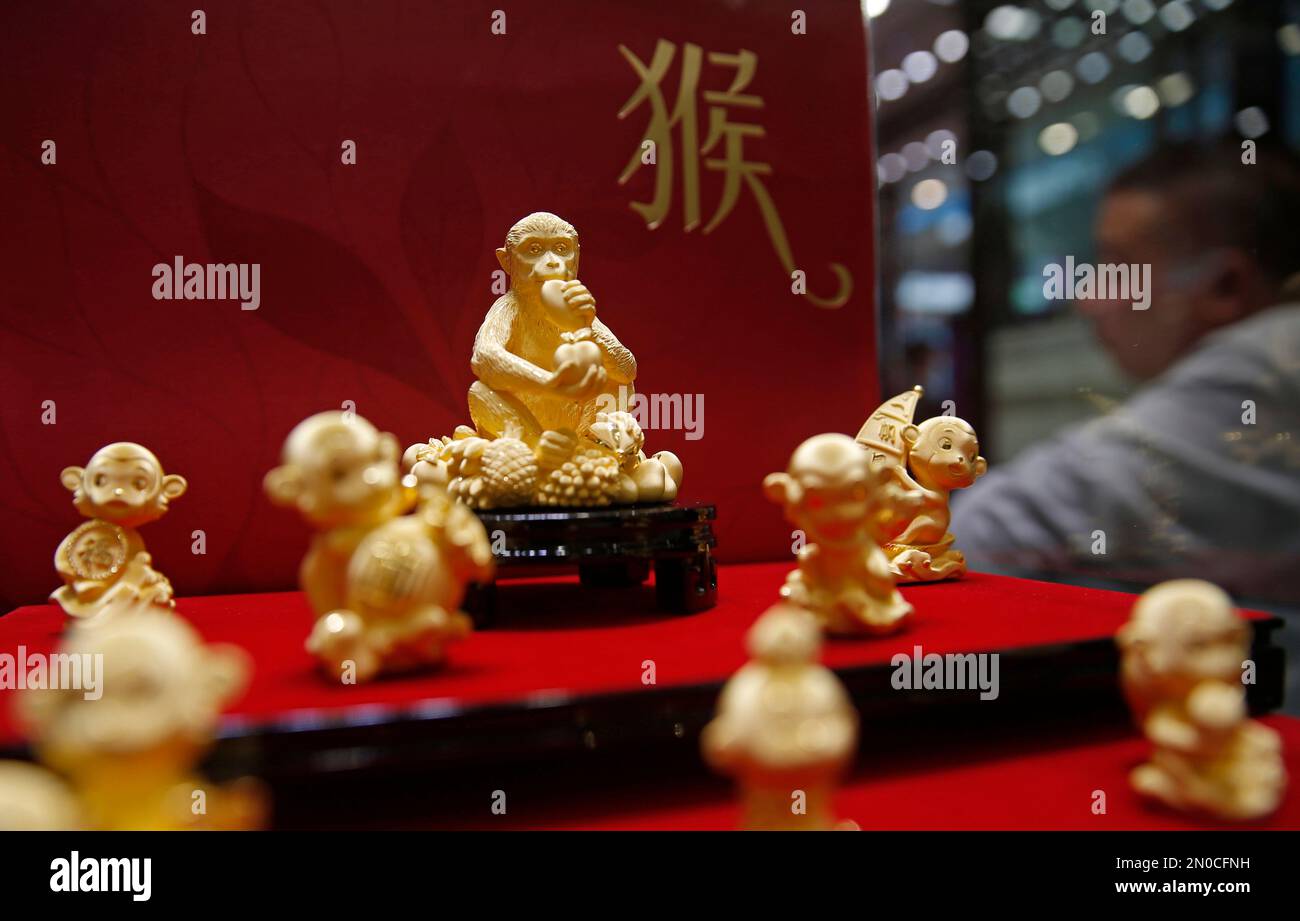 A set of newly unveiled gold monkeys are on display for sale ahead of ...