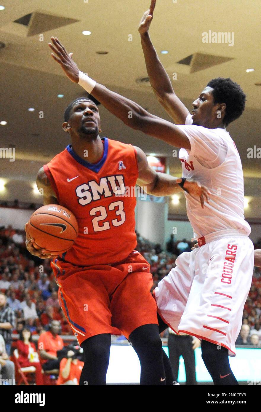 Southern Methodist's Jordan Tolbert (23) is fouled by Houston's LeRon ...