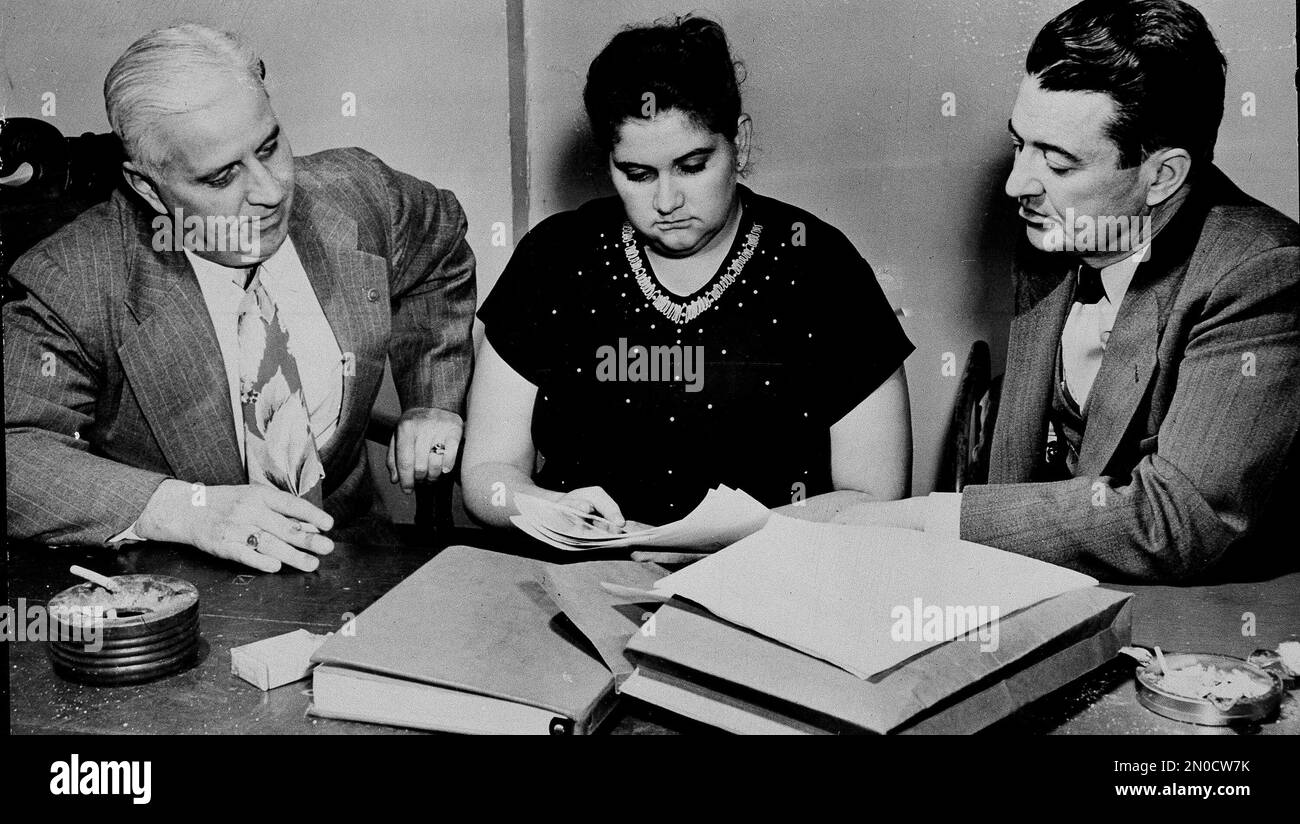 Martha Beck, 29-year-old partner of Raymond Fernandez, looks at photos of crime scene in the New ...