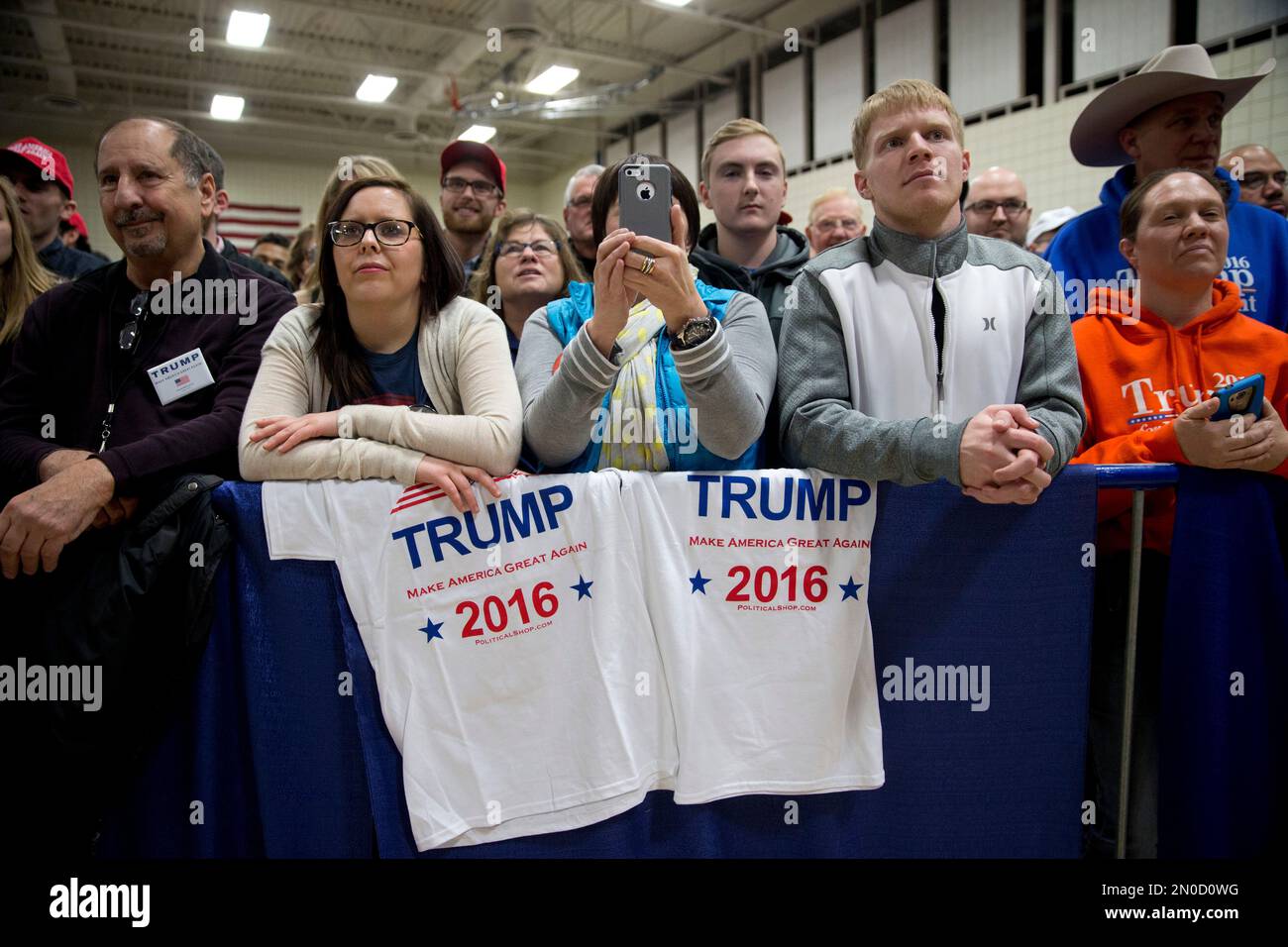 People listen to Republican presidential candidate Donald Trump at a ...