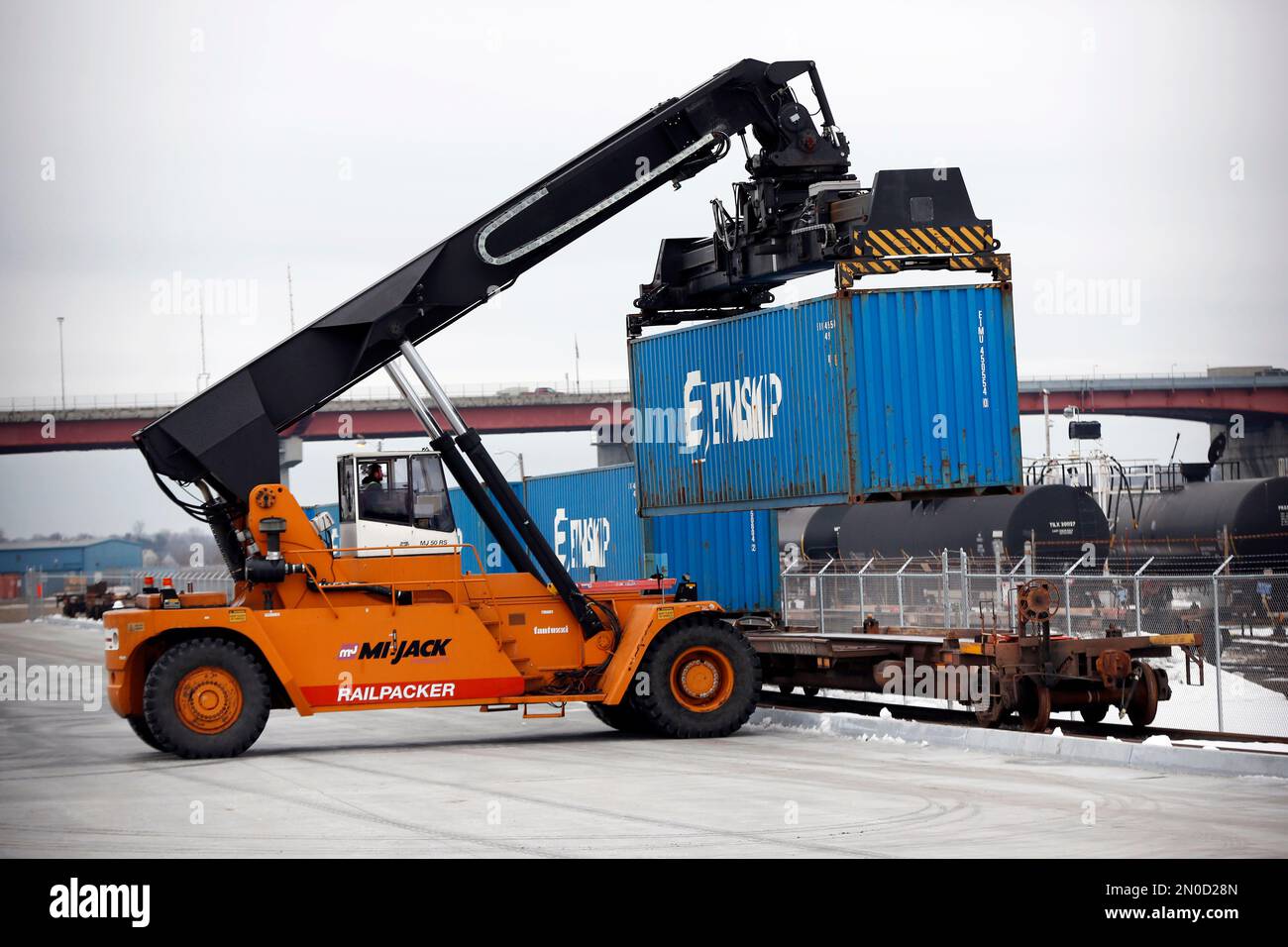 In this Friday, Jan. 29, 2016 photo, a reach stackers loads a train car ...