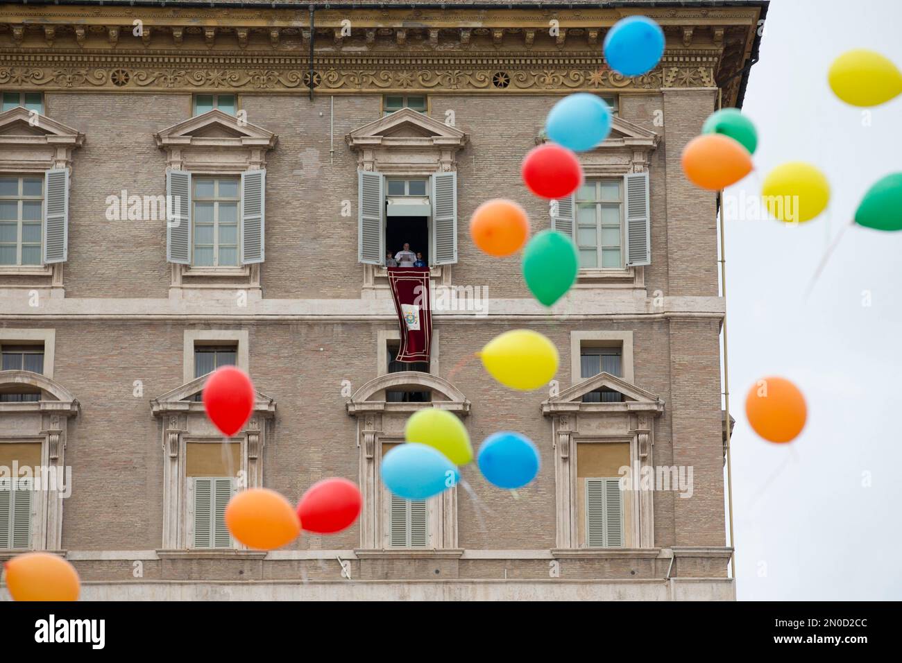 Colored balloons float in air as Pope Francis celebrates the Angelus ...