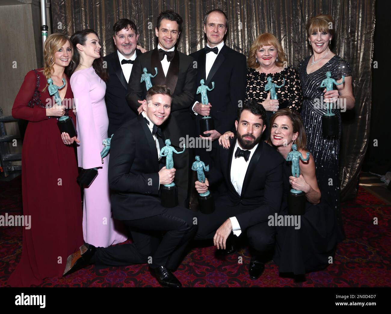 The cast of "Downton Abbey" is seen backstage with the award for ...