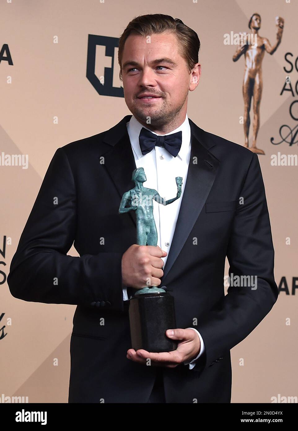 Leonardo DiCaprio poses in the press room with the award for ...