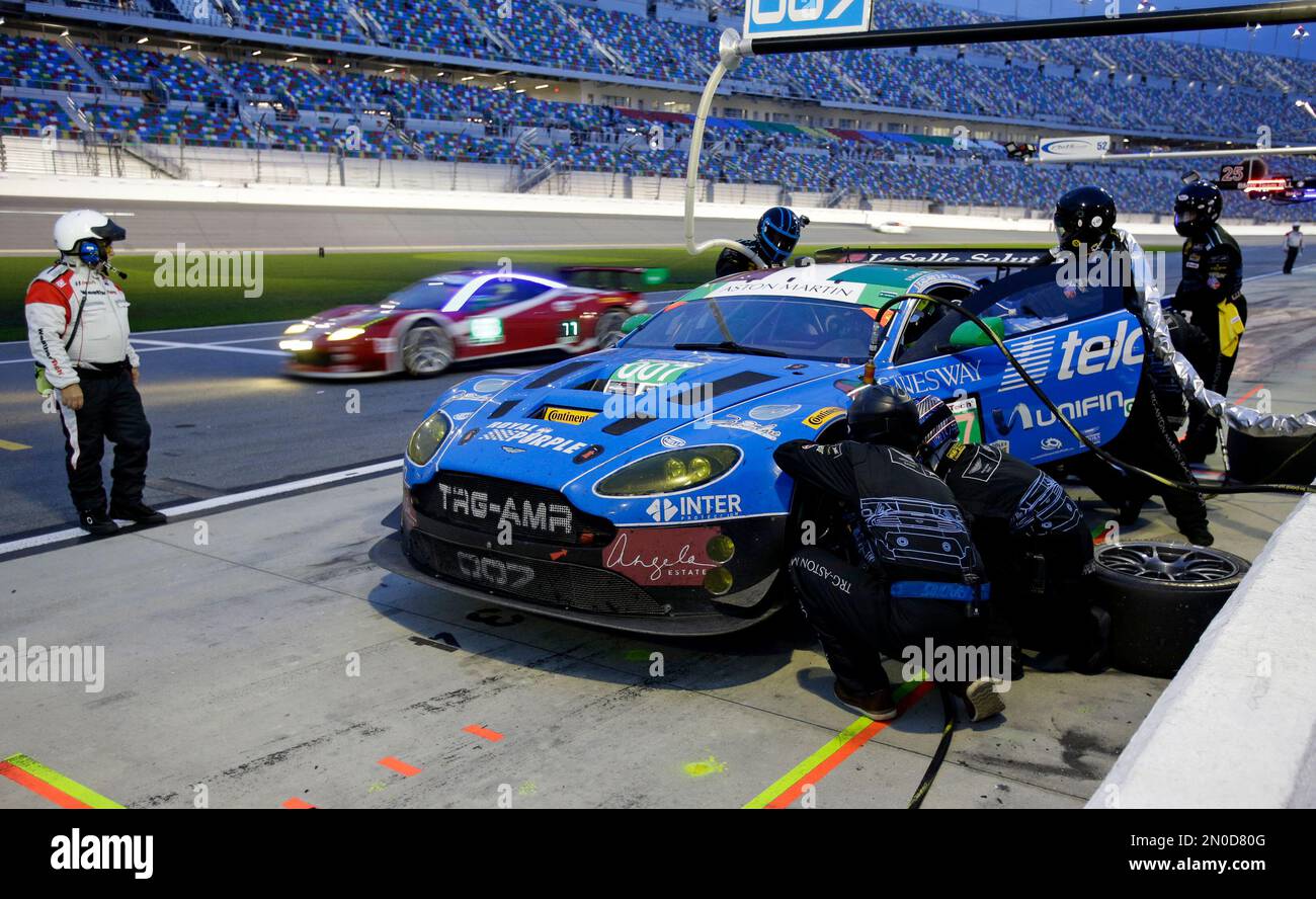The crew of the TRG-AMR team adds fuel to and changes tires on the ...
