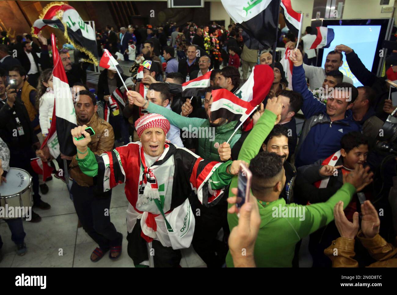 Iraqi soccer fans celebrate as they wait for their team at Baghdad ...
