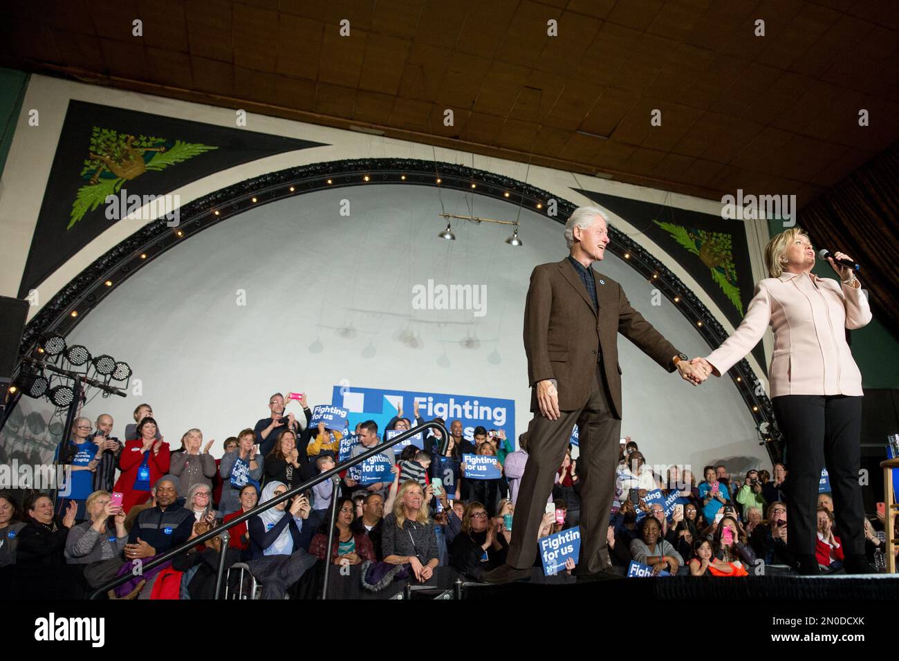 Democratic presidential candidate Hillary Clinton holds hands with her ...