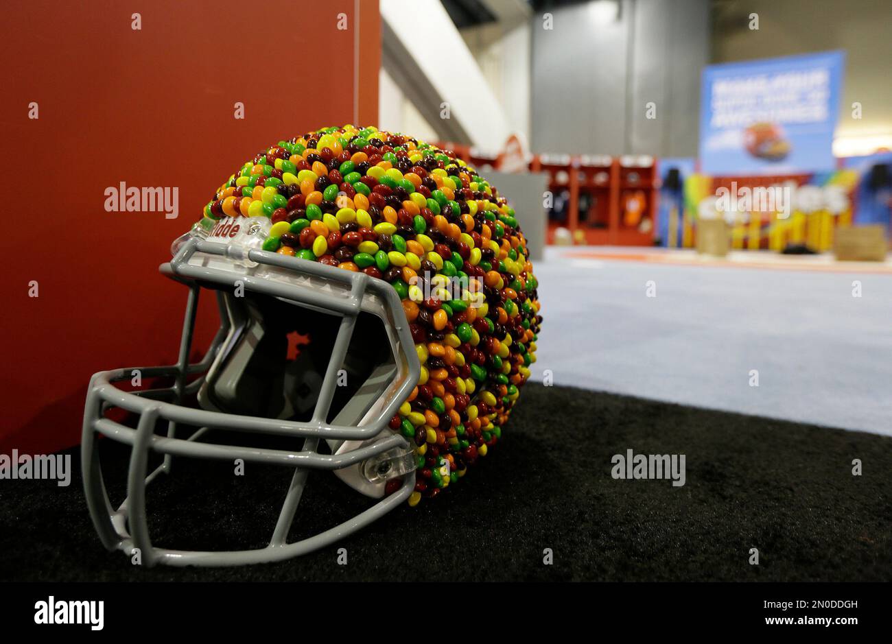 A football helmet covered in Skittles is seen at the NFL Experience ...