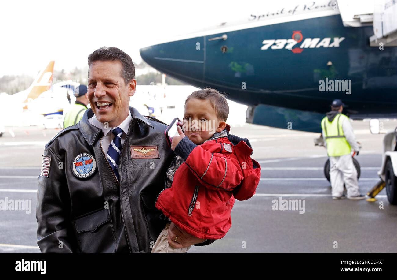 Boeing pilot Craig Bomben holds his son, Luca, after helping fly a ...