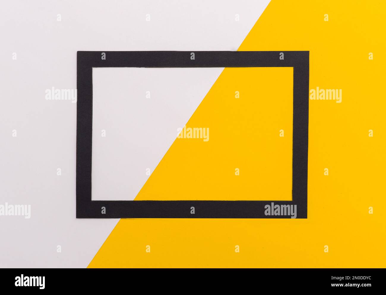 Black frame on white and yellow diagonally divided background Stock ...