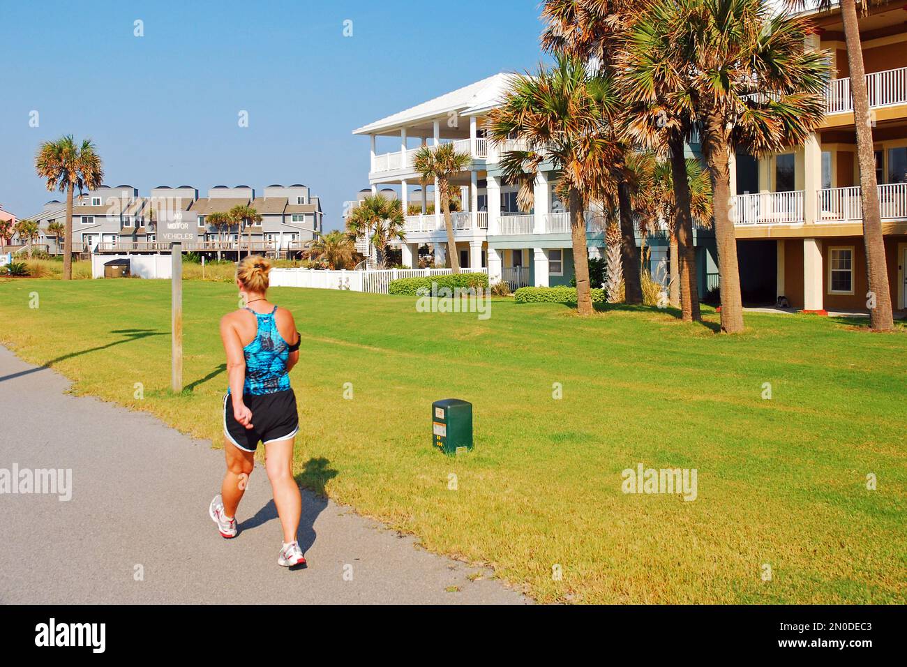 A young woman walks along a pedestrian path near the shore in Pensacola ...