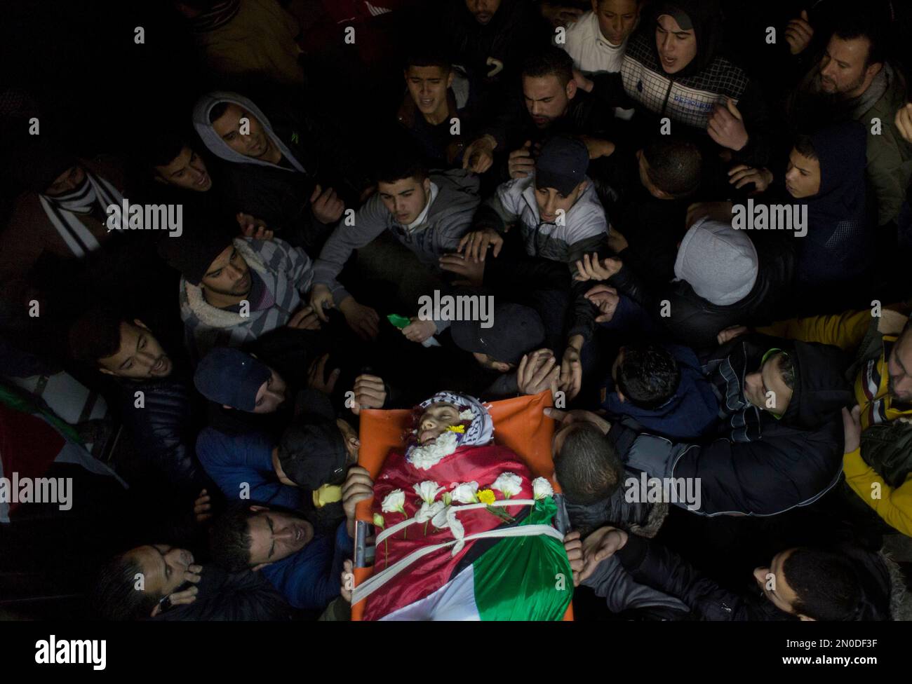 Palestinian mourners carry the body Hussein Abu Ghosh, 17 during his ...