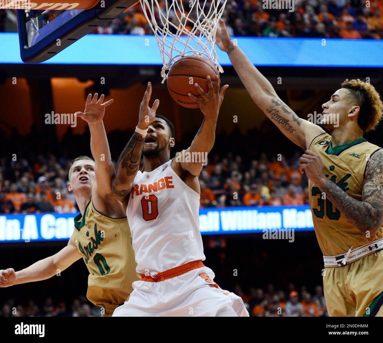 Syracuse's Michael Gbinije, center, goes up for a basket against Notre ...