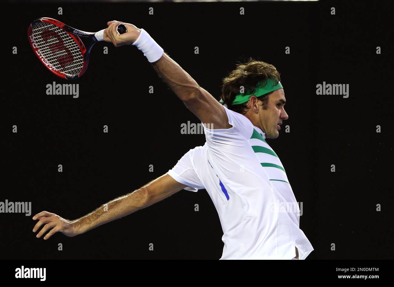 Roger Federer of Switzerland plays a backhand return to Novak Djokovic ...