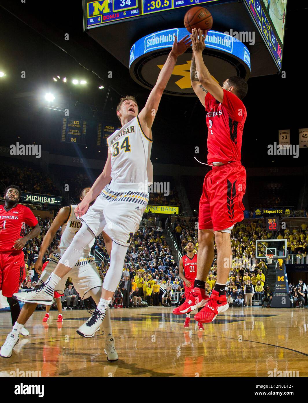 Michigan forward Mark Donnal (34) defends a shot attempt from Rutgers ...