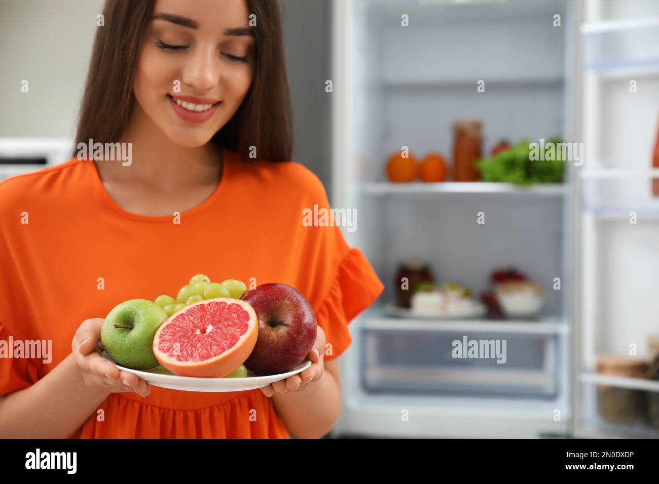 Concept of choice between healthy and junk food. Woman holding plate ...