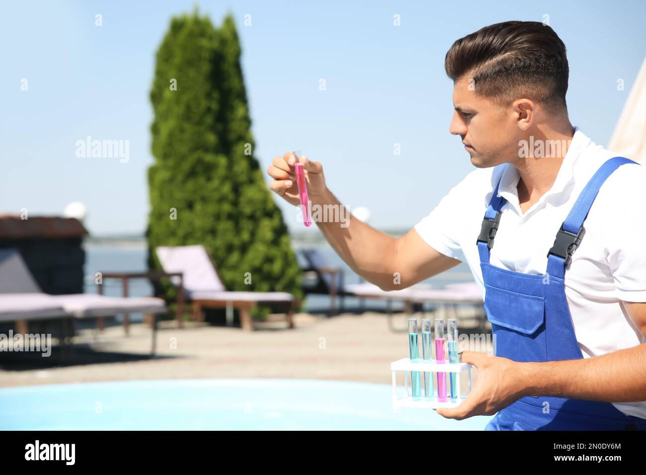 Man holding test tubes with reagents near swimming pool Stock Photo - Alamy