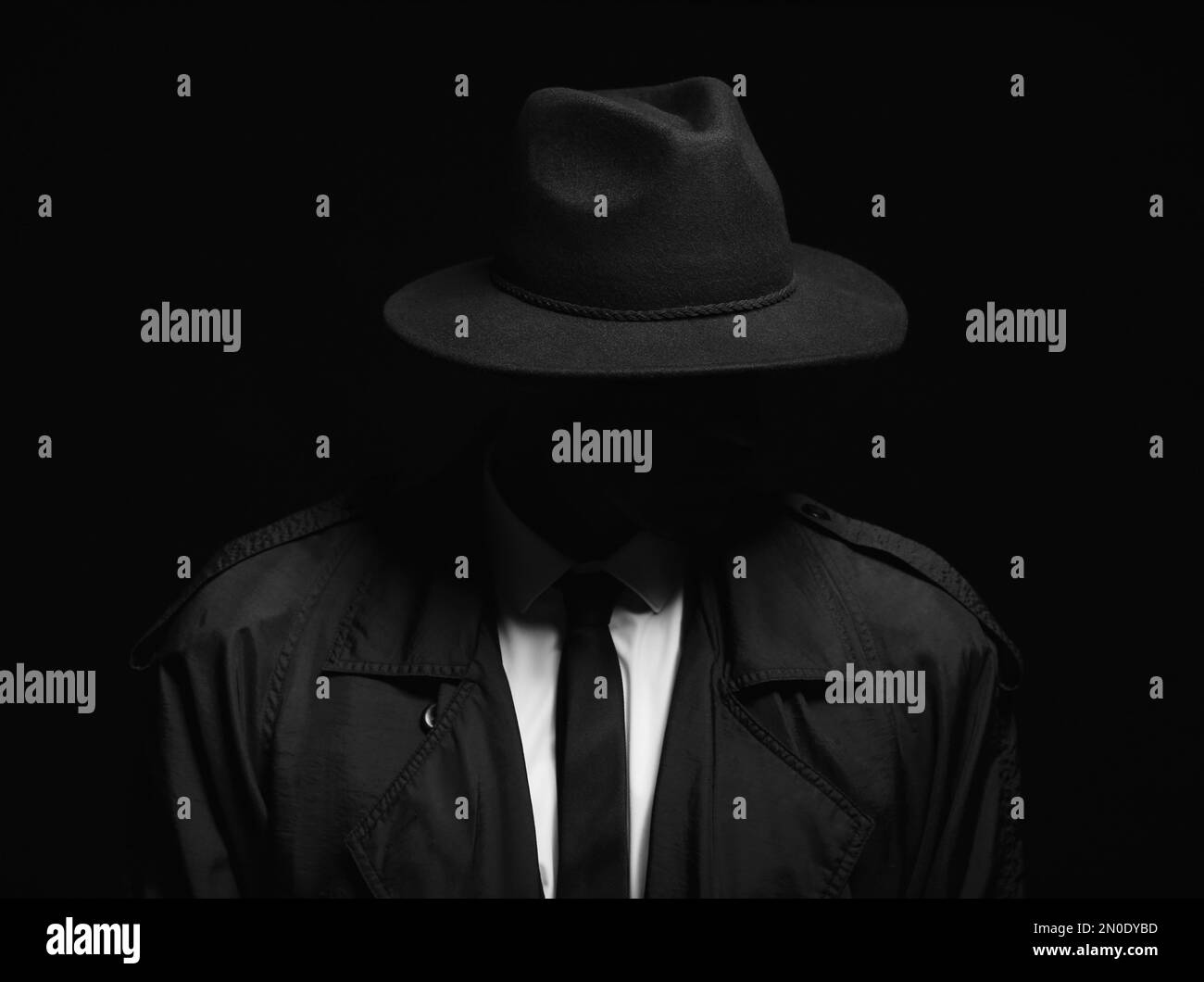 Old fashioned detective in hat on dark background Stock Photo - Alamy