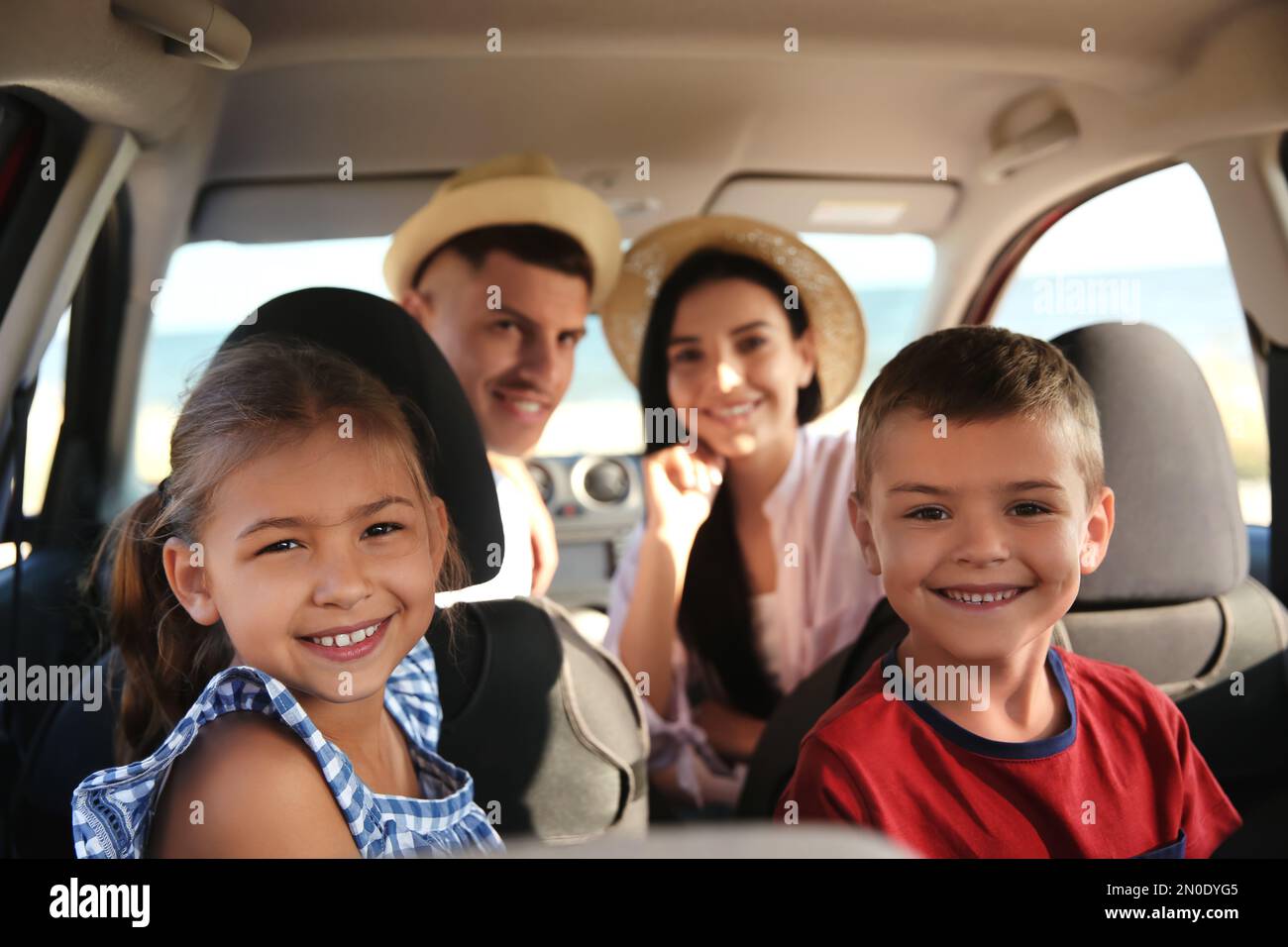 Happy family in car on road trip Stock Photo - Alamy