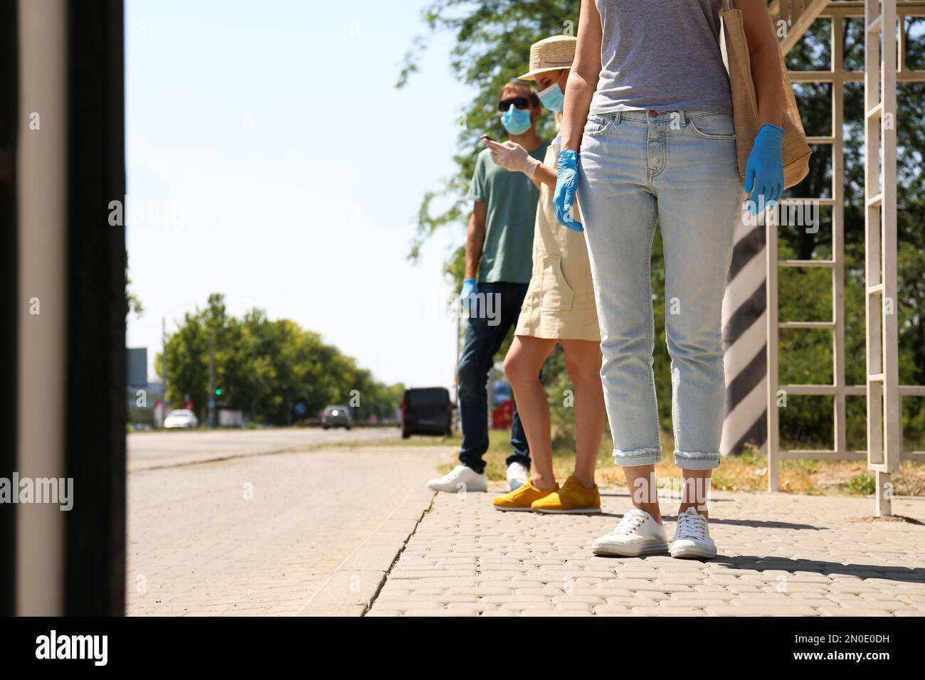 People keeping social distance in line at bus stop. Coronavirus ...