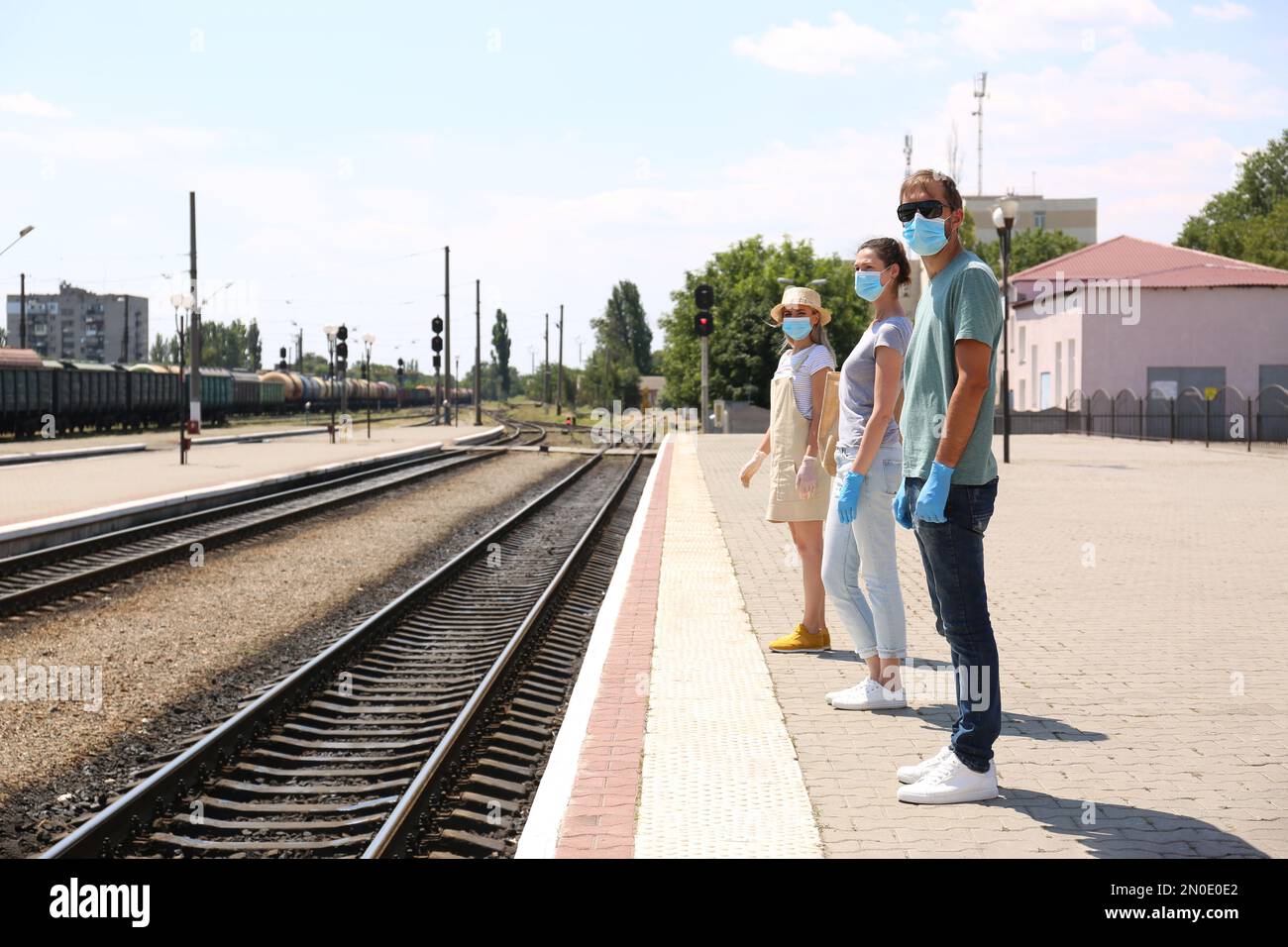 People keeping social distance in line at train station. Coronavirus ...