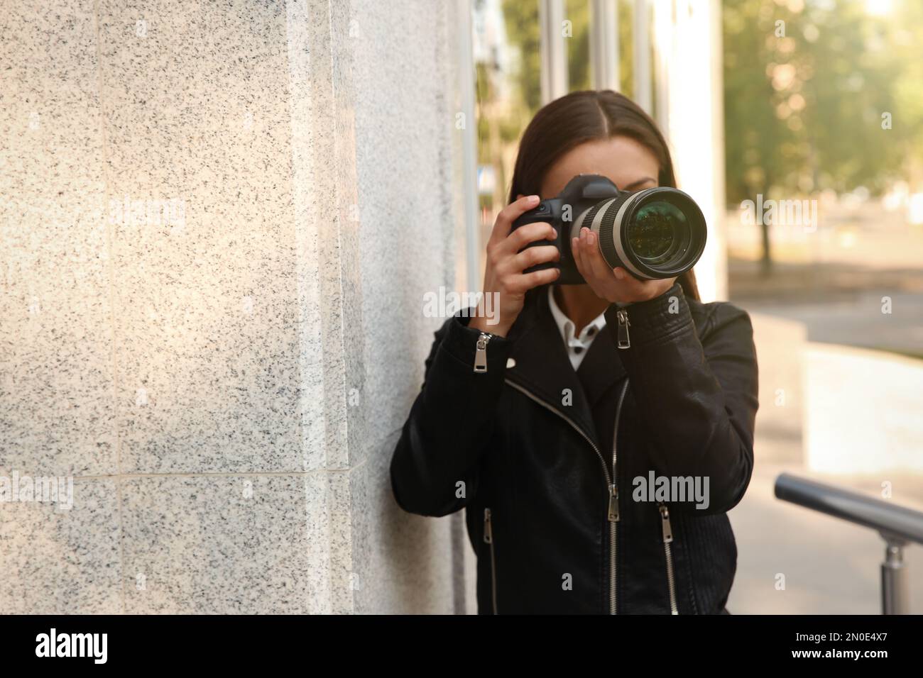 Private detective with camera spying near building on city street Stock ...