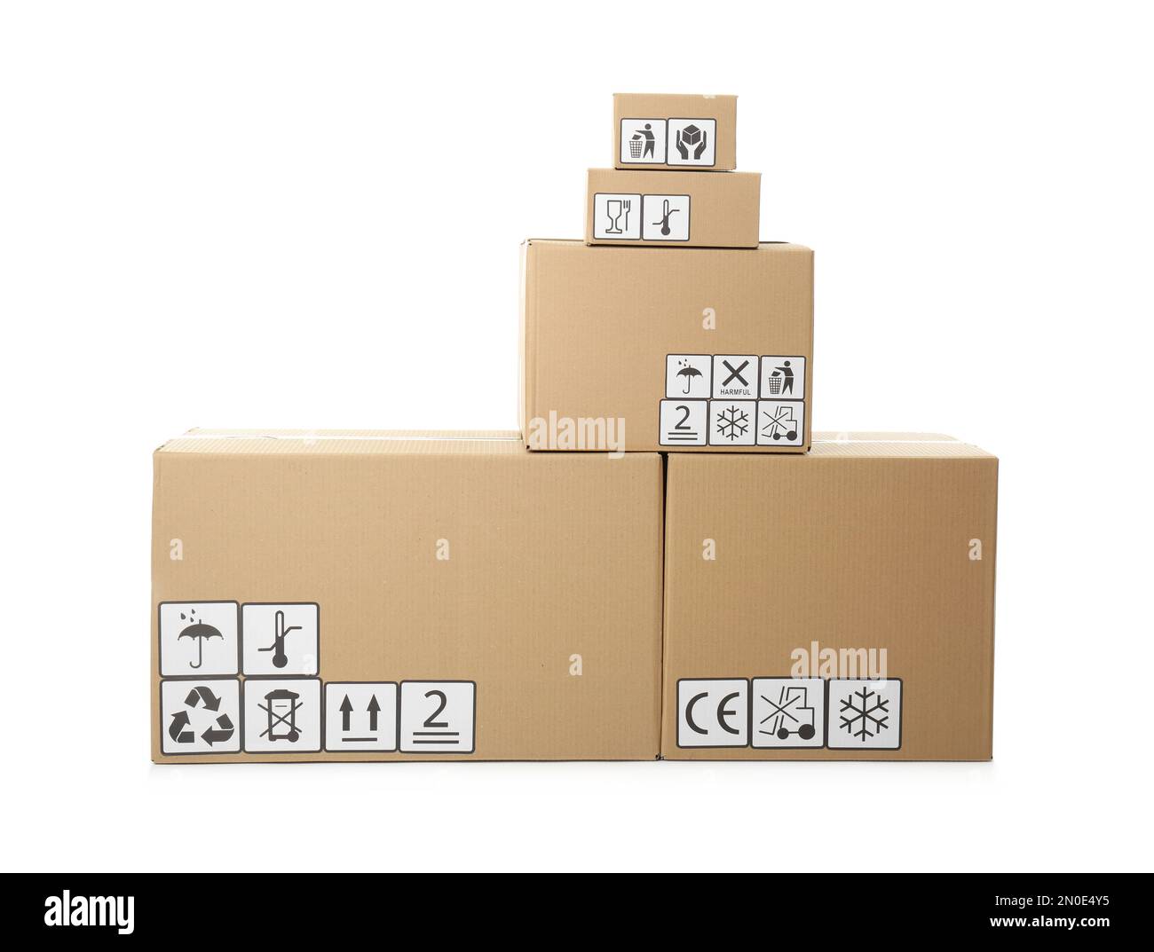 Stack of cardboard boxes with different packaging symbols on white ...