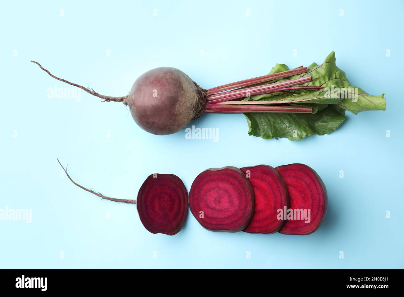 Whole and cut fresh red beets on light blue background, flat lay Stock ...