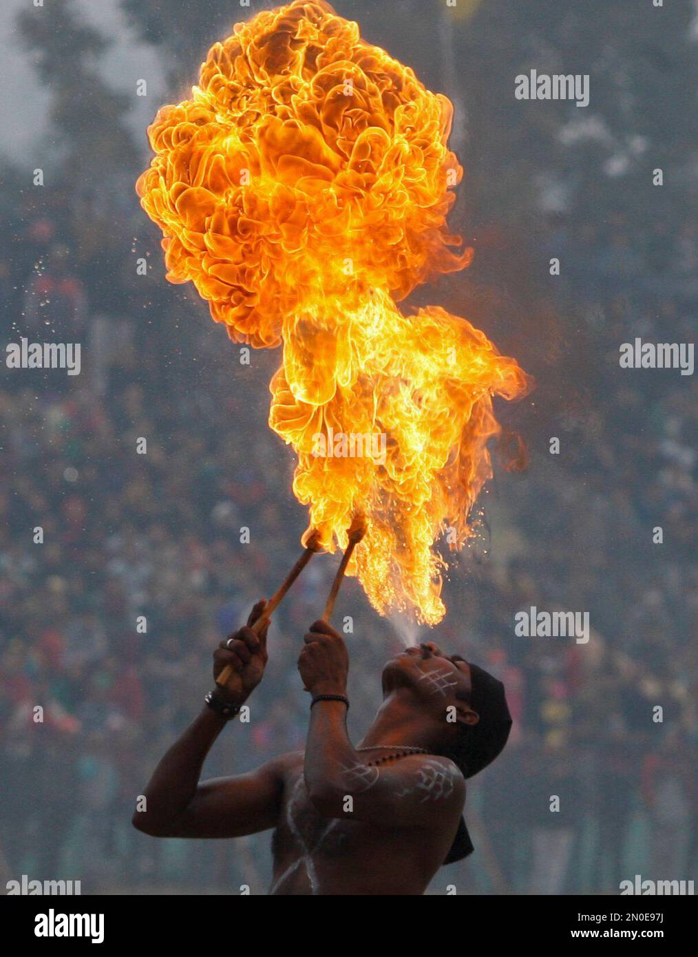 An Indian artist performs a fire act during Republic Day celebrations ...