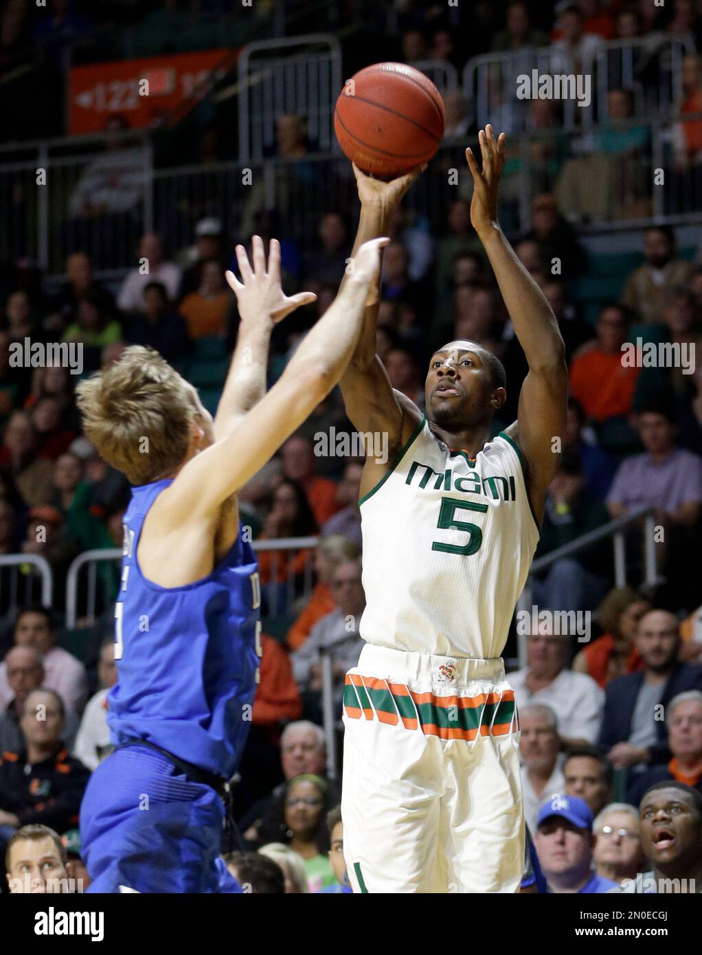 Miami guard Davon Reed (5) prepares to shoot over Duke guard Luke ...