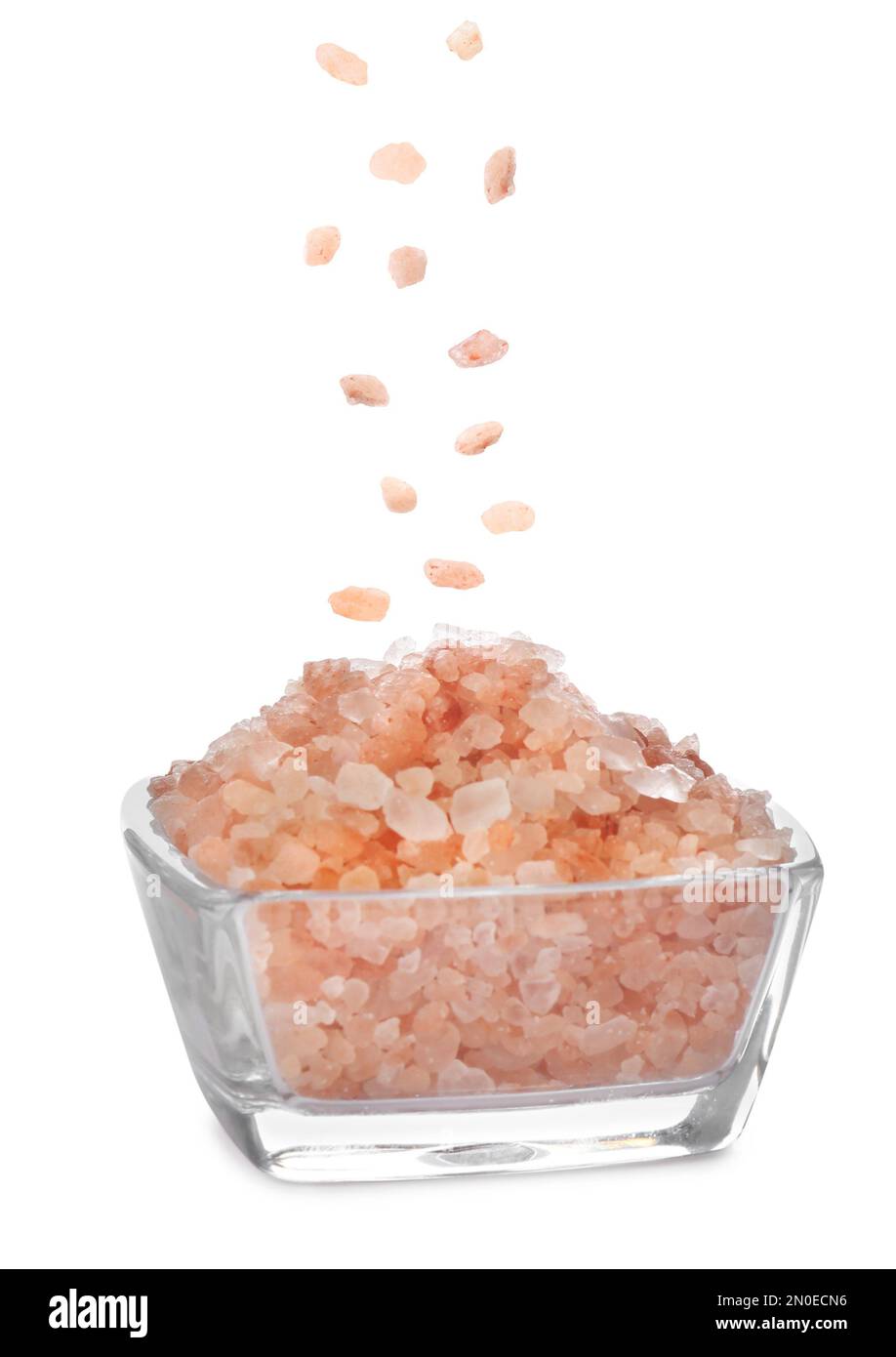Pink himalayan salt falling into bowl on white background Stock Photo ...