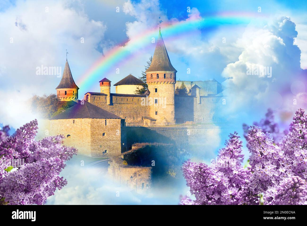 Fantasy world. Beautiful rainbow in sky with fluffy clouds over ...