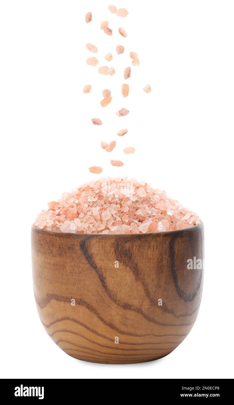Pink himalayan salt falling into bowl on white background Stock Photo ...