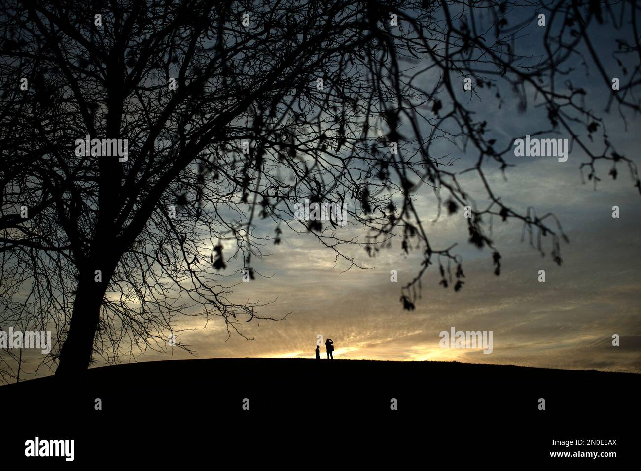 A couple take photographs atop a hill at the Tio Pio park in Madrid ...
