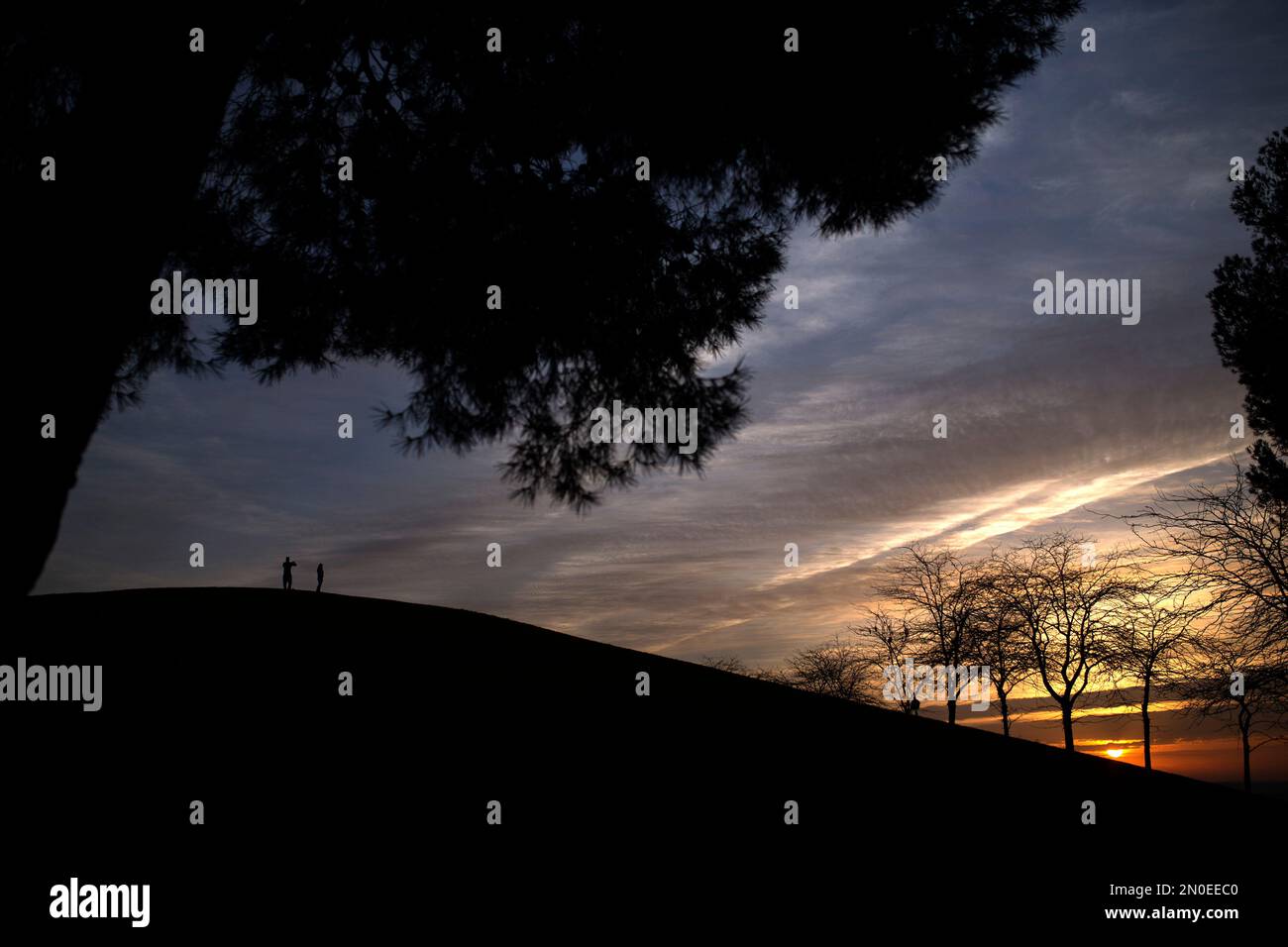 A couple take photographs atop a hill at the Tio Pio park in Madrid ...