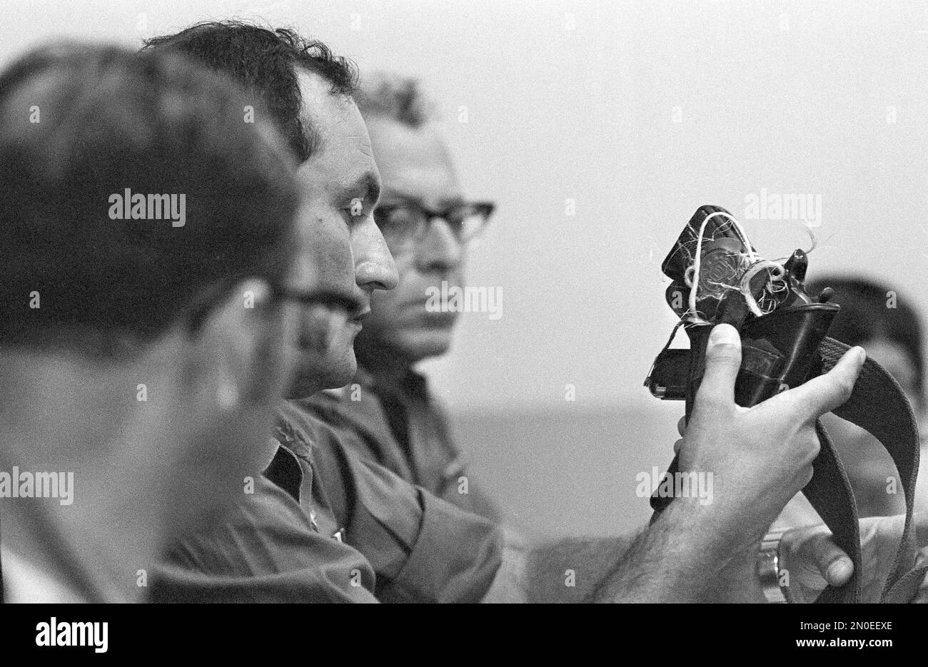 Israeli military judges examine a revolver taken from an Arab man ...