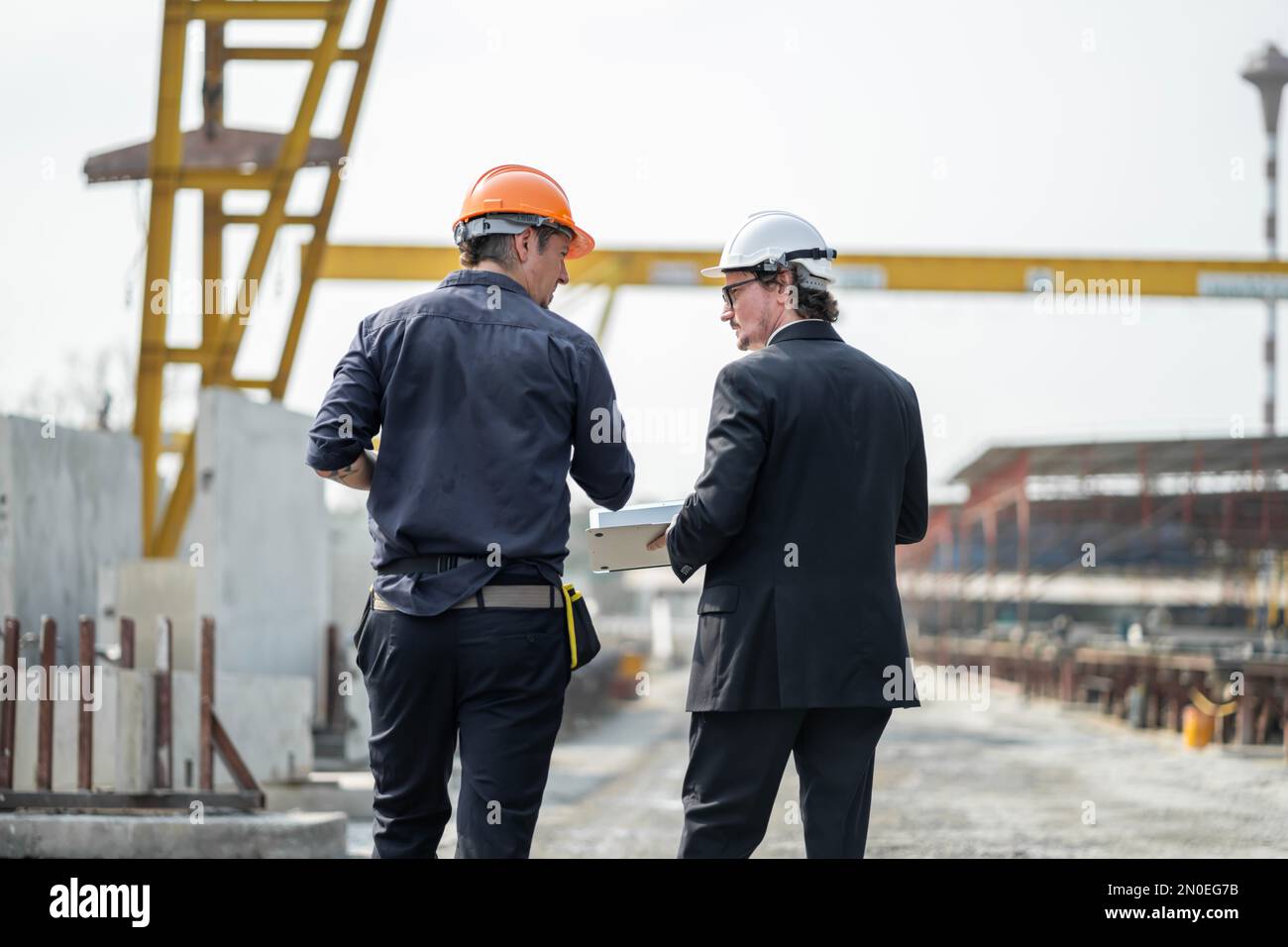 Male engineers are inspecting and controlling the work of the employees ...