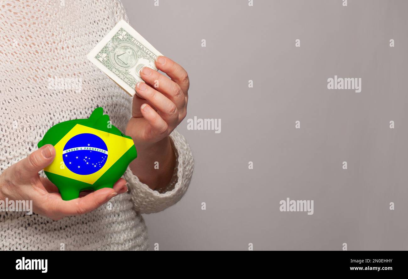 Flag of Brazil on money bank in Brazilian woman hands. Dotations ...