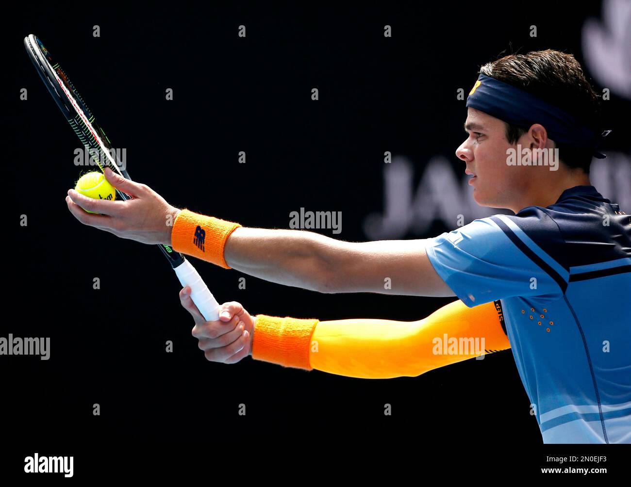 Milos Raonic of Canada prepares to serve to Stan Wawrinka of ...