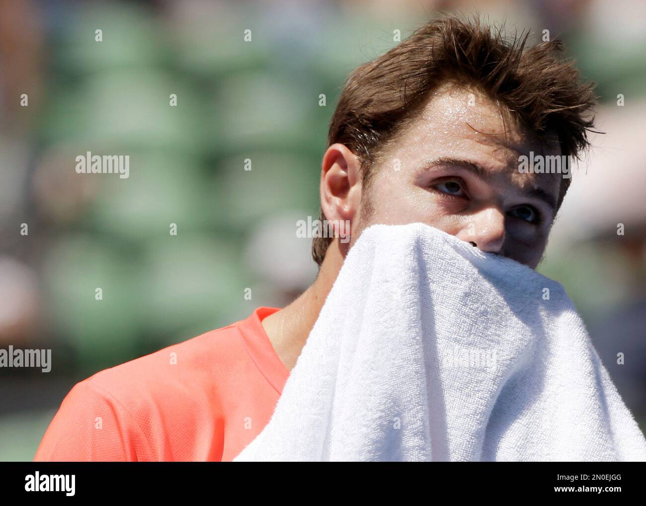 Stan Wawrinka of Switzerland wipes the sweat from his face during his ...